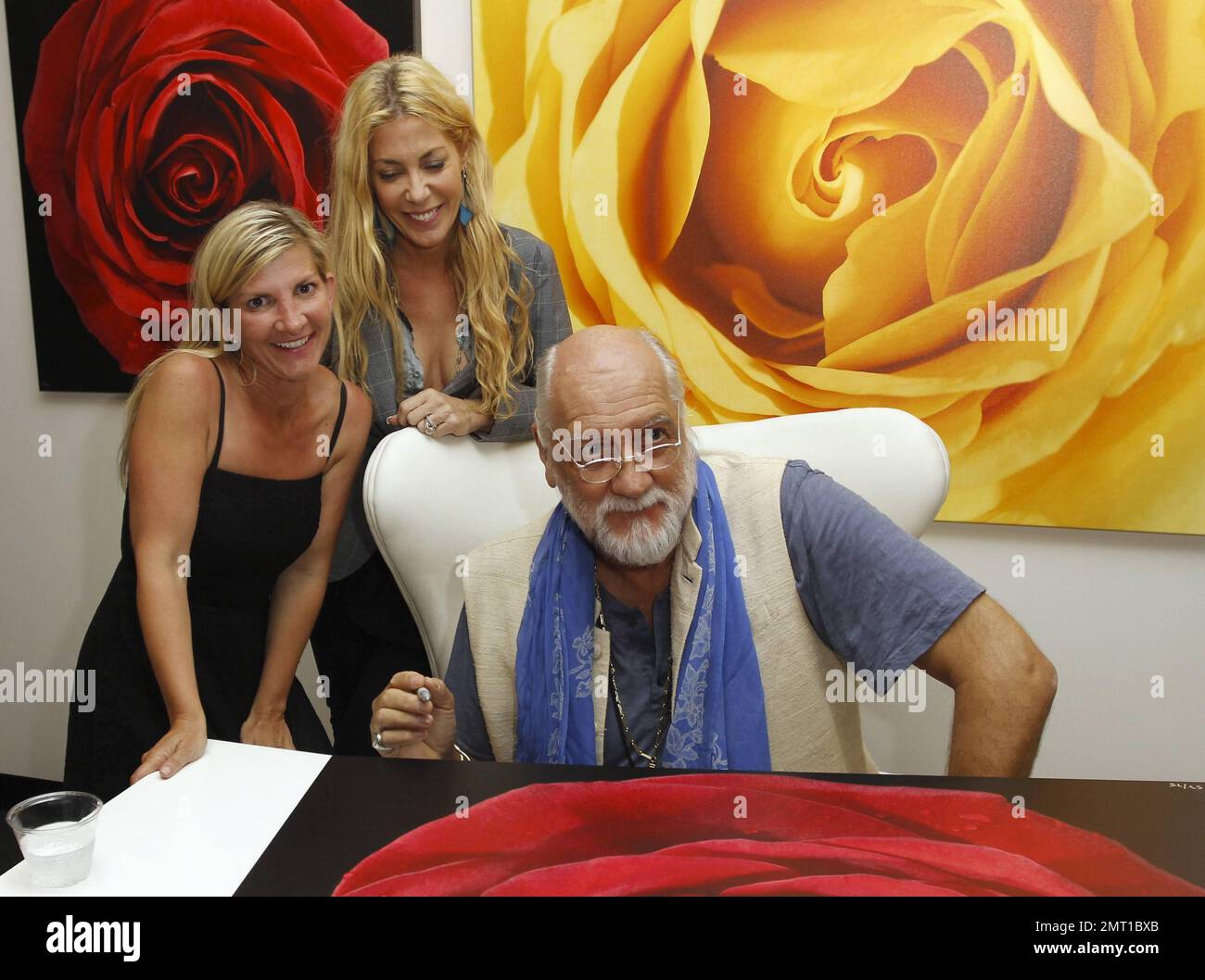 Mick Fleetwood signs copies of his work during the Rhythm of a Rose ...