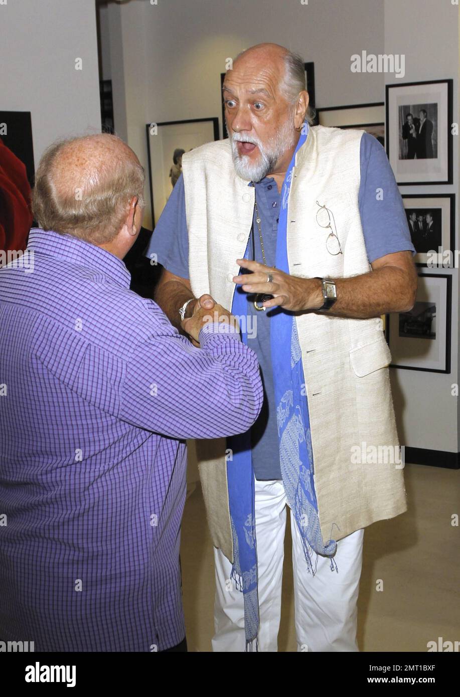 Mick Fleetwood signs copies of his work during the Rhythm of a Rose ...