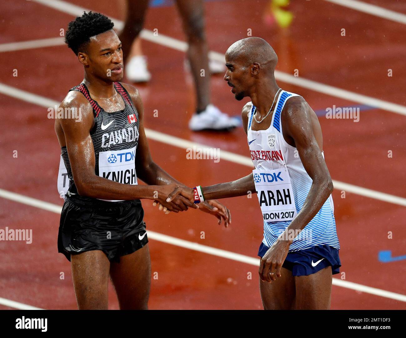 Britain's Mohamed Farah, right, shakes hands with Canada's Justyn ...
