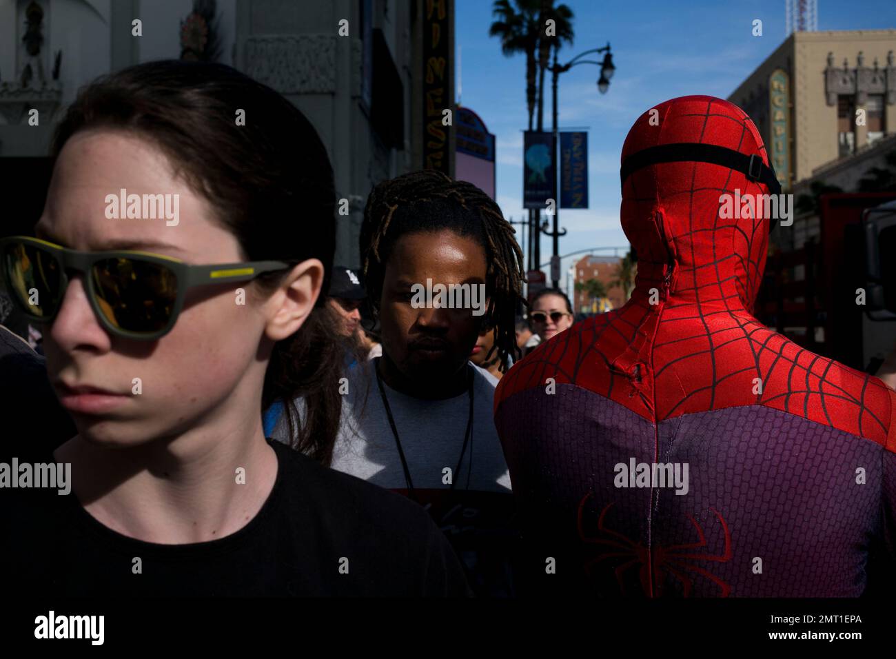Superhero impersonator and actor Dan Inigo, right, wades into the crowd ...