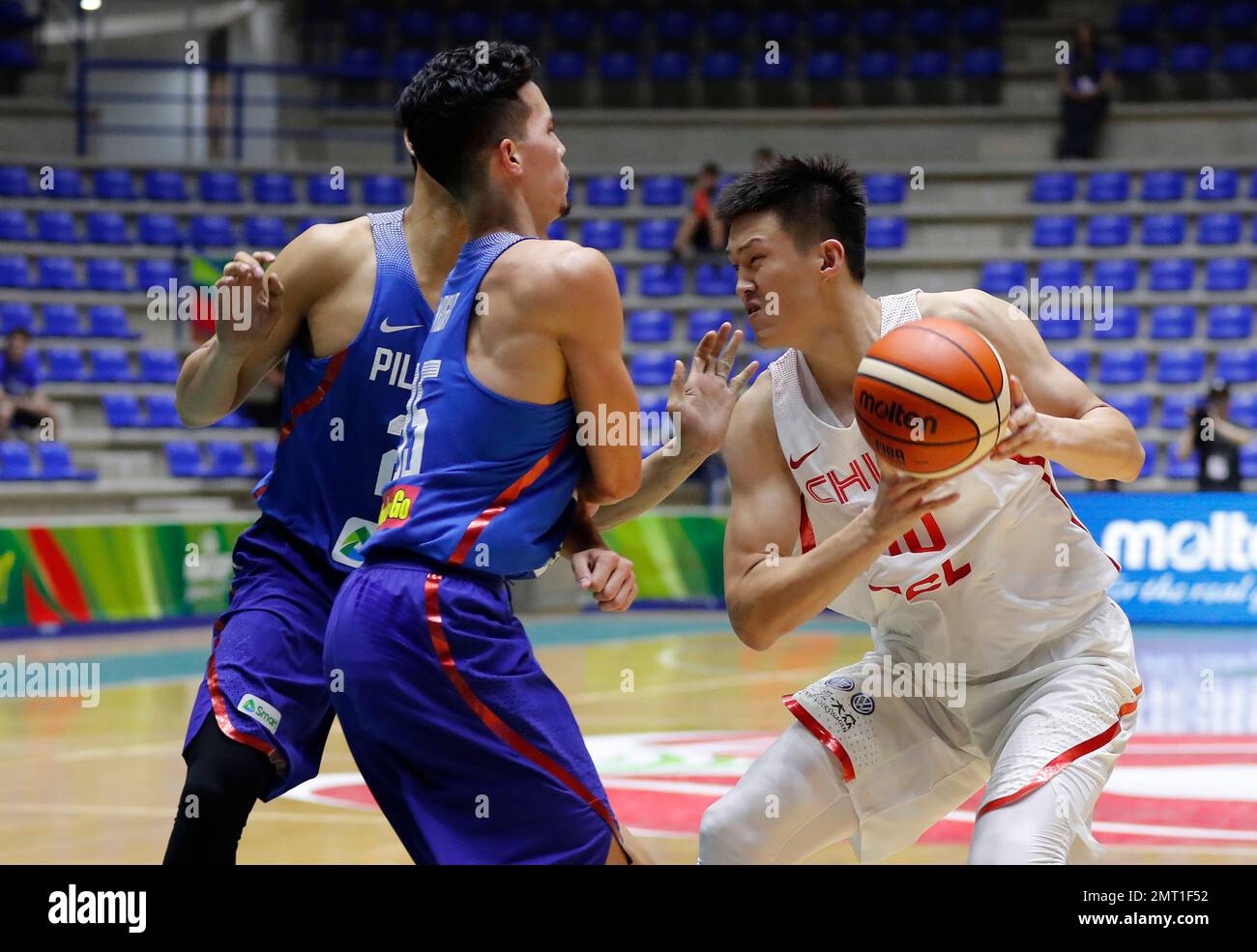 China's Zhou Peng, right, challenges for the ball against Philippines ...