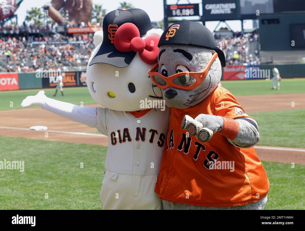 A Hello Kitty mascot poses with San Francisco Giants mascot Lou Seal as ...