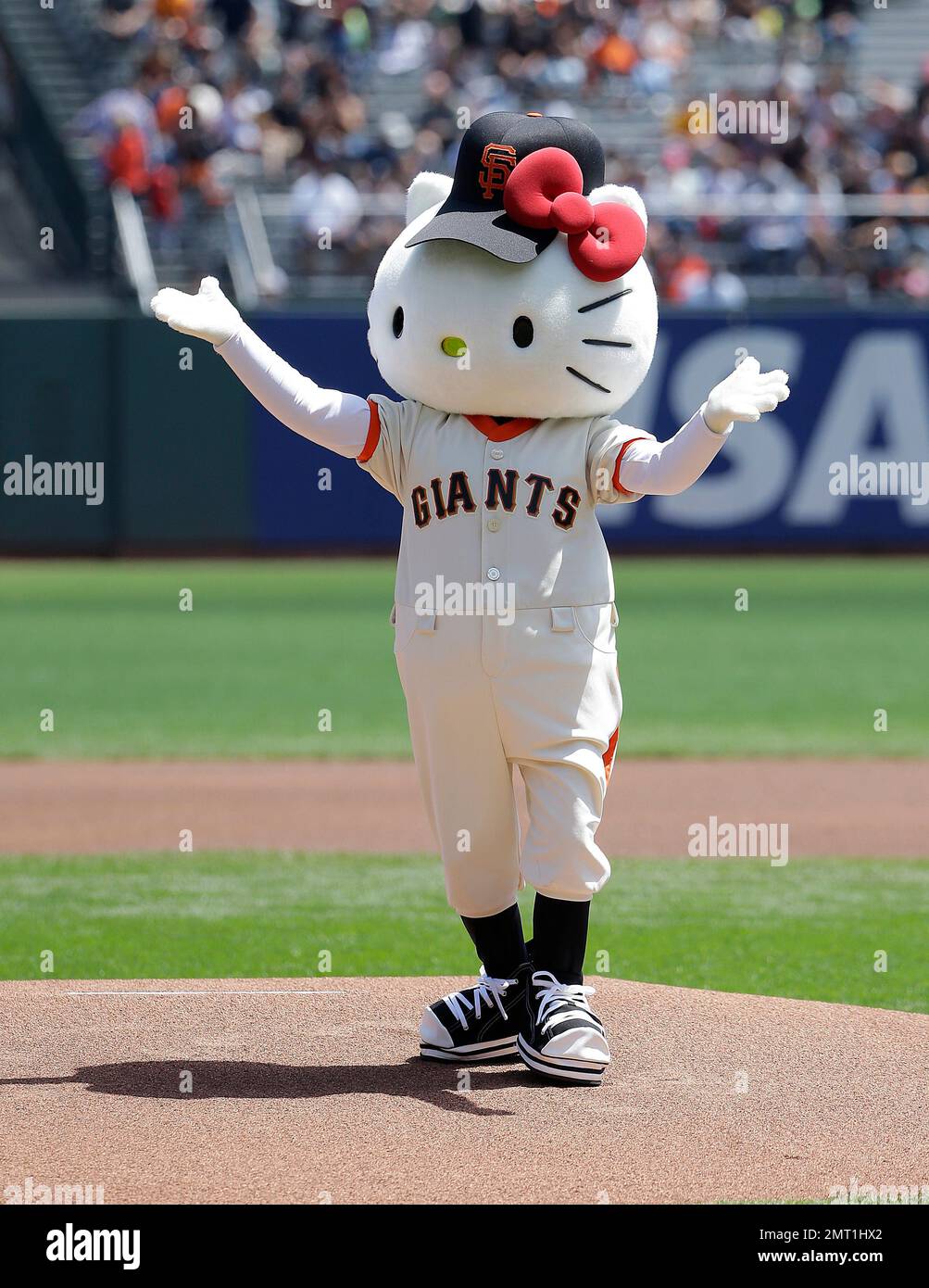 A Hello Kitty mascot gestures after throwing out the ceremonial first ...