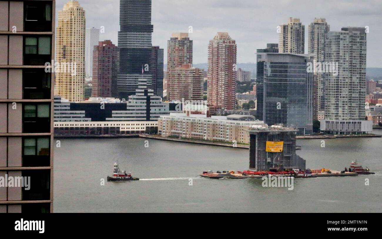 Tug boats guide a barge with a $195 million heat-recovery steam ...