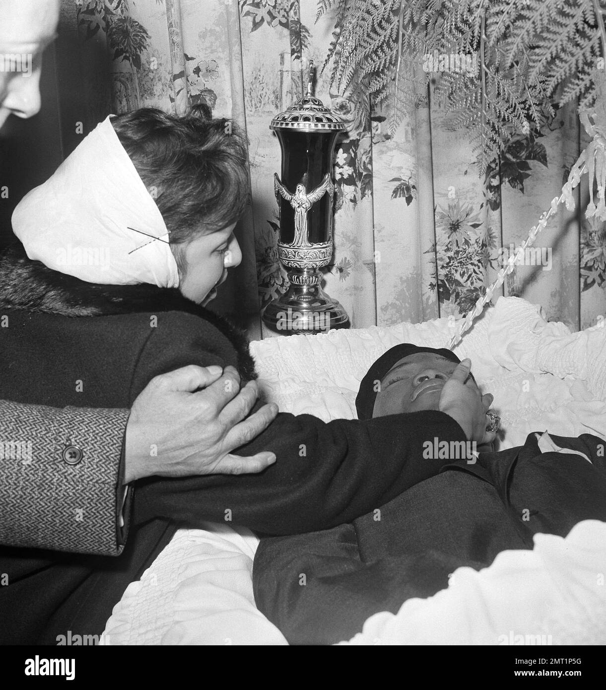 A friend restrains Lucy Paret, widow of boxer Benny Paret, as she holds ...