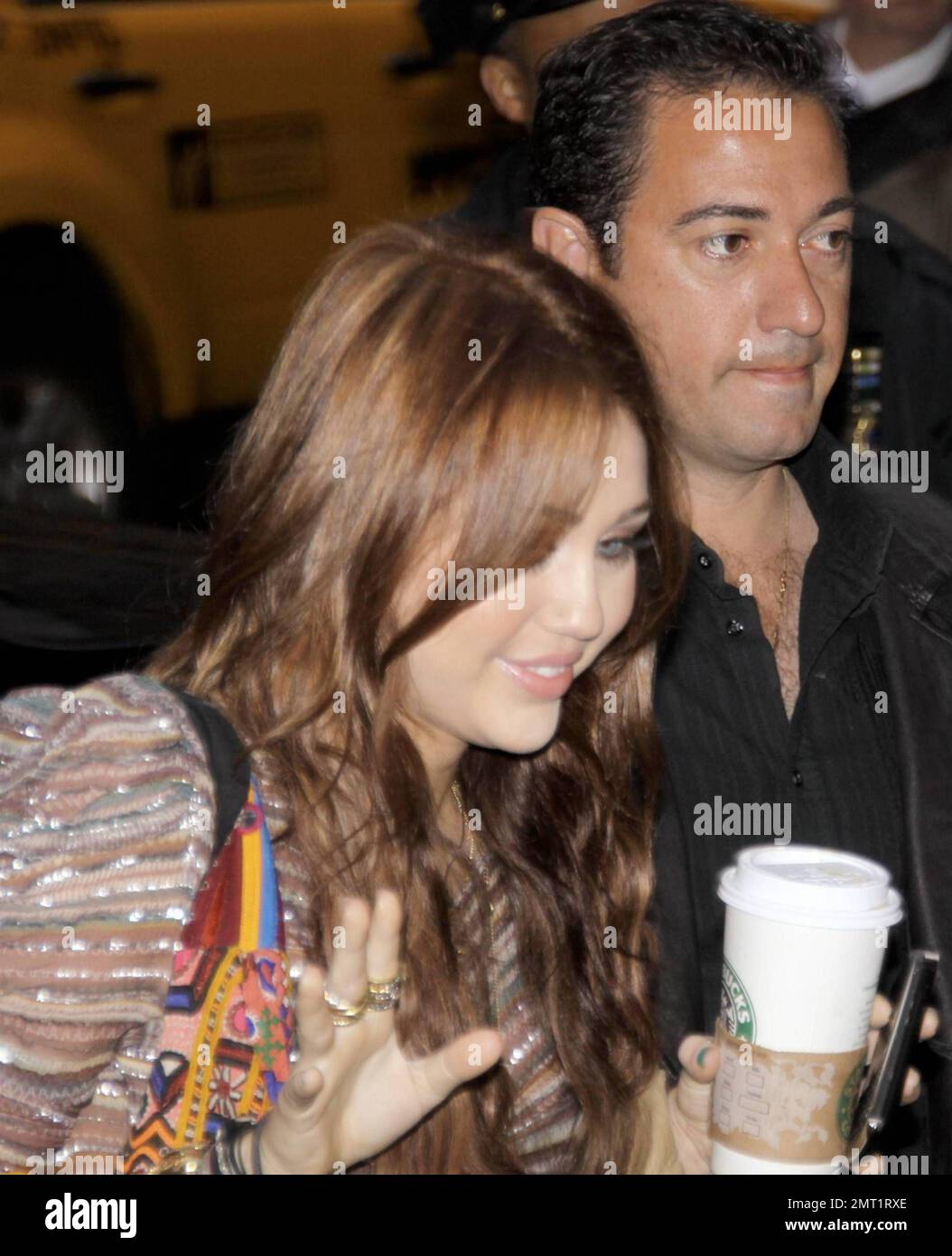 Miley Cyrus brings along a Starbuck's coffee as she arrives with sister ...