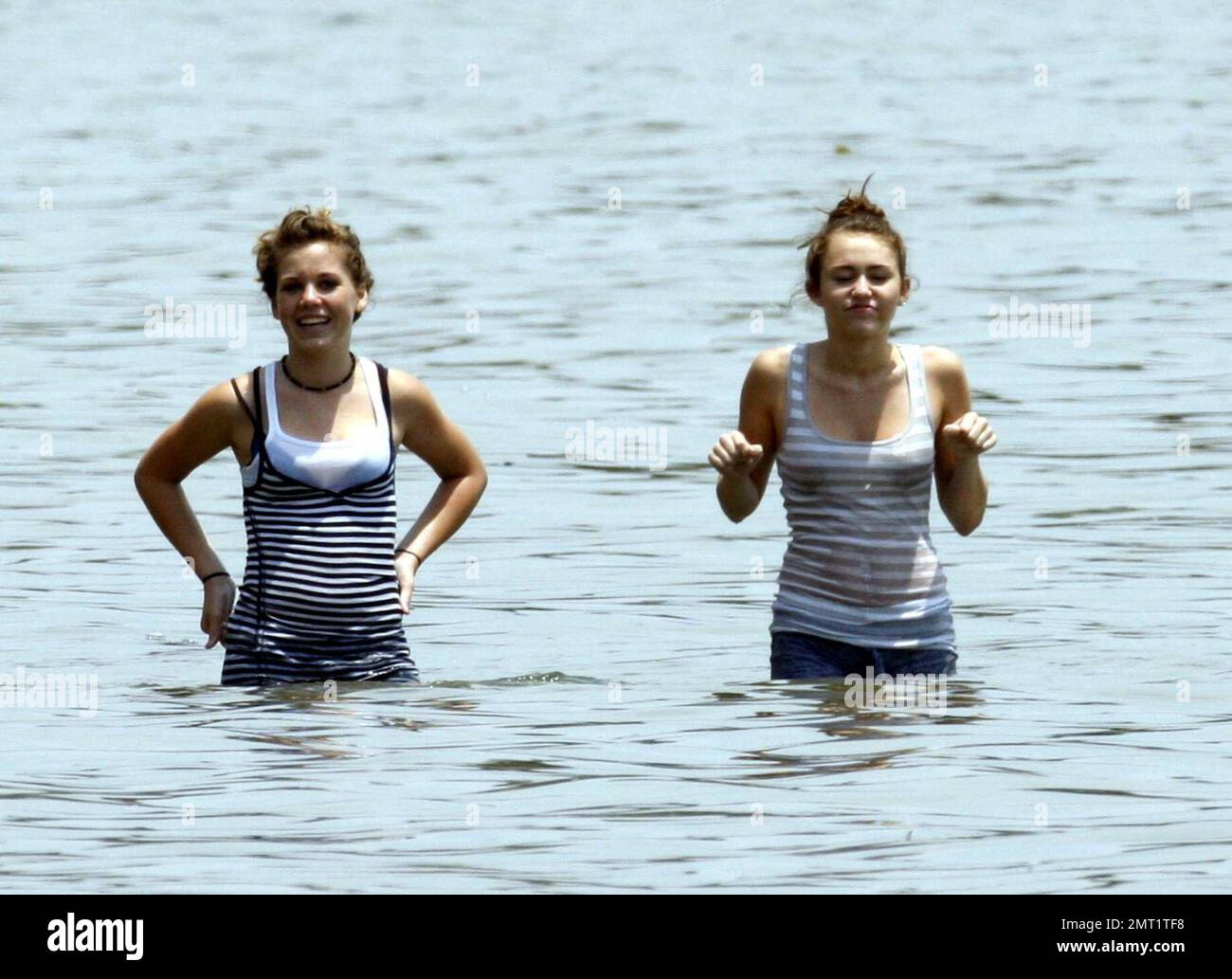 Miley Cyrus frolics in the surf with friends/castmates while filming ...