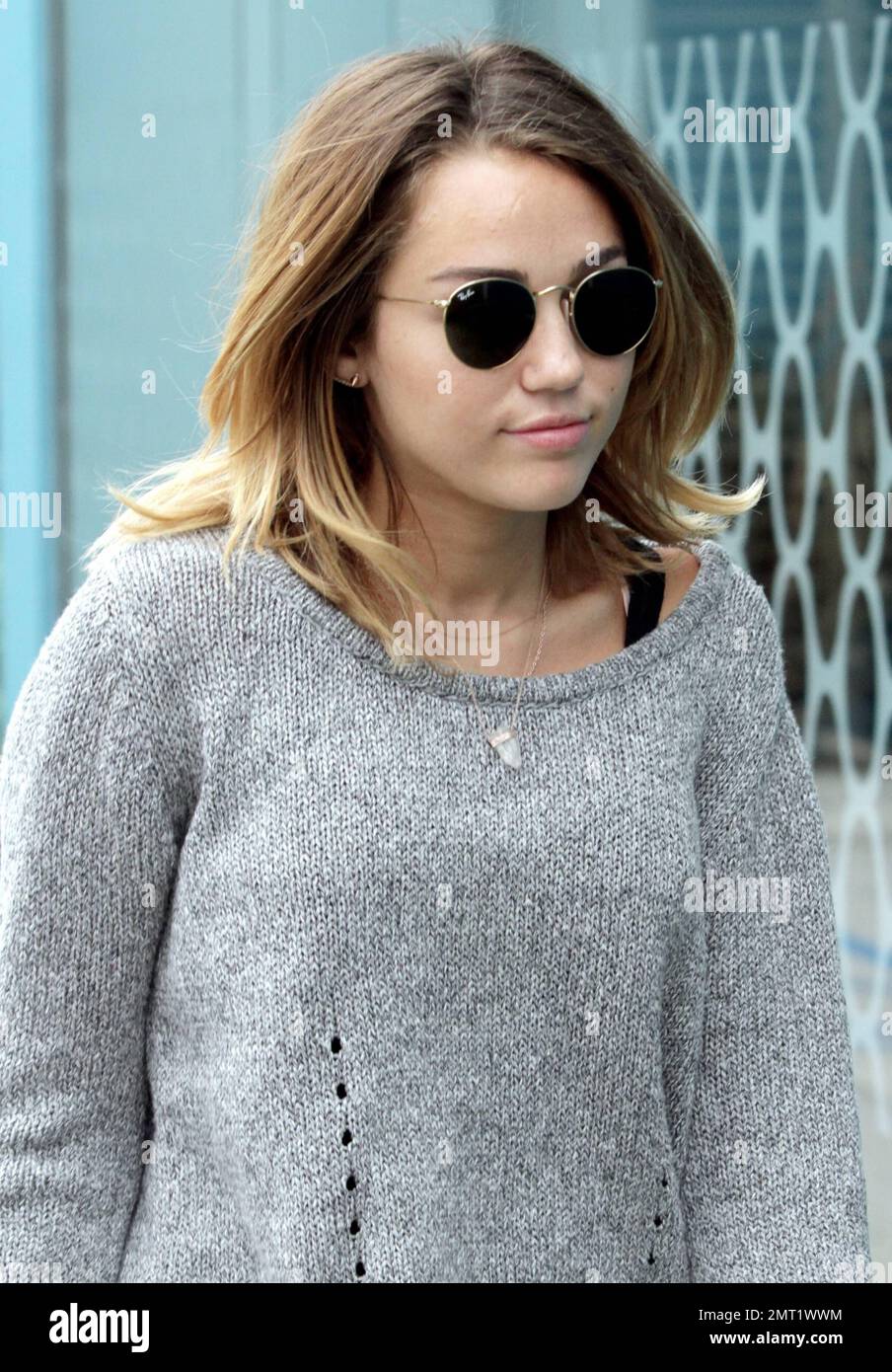 Wearing a grey sweater over her all-black workout outfit, Miley Cyrus ...