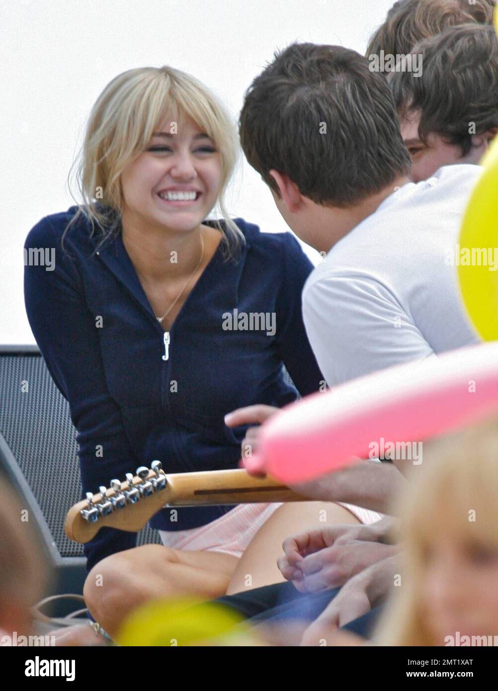 Miley Cyrus has fun on the rides with her sister (check) at the Santa ...