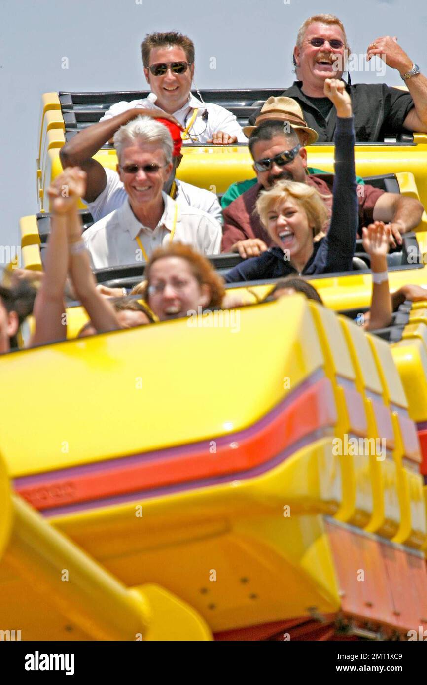 Miley Cyrus has fun on the rides with her sister (check) at the Santa ...