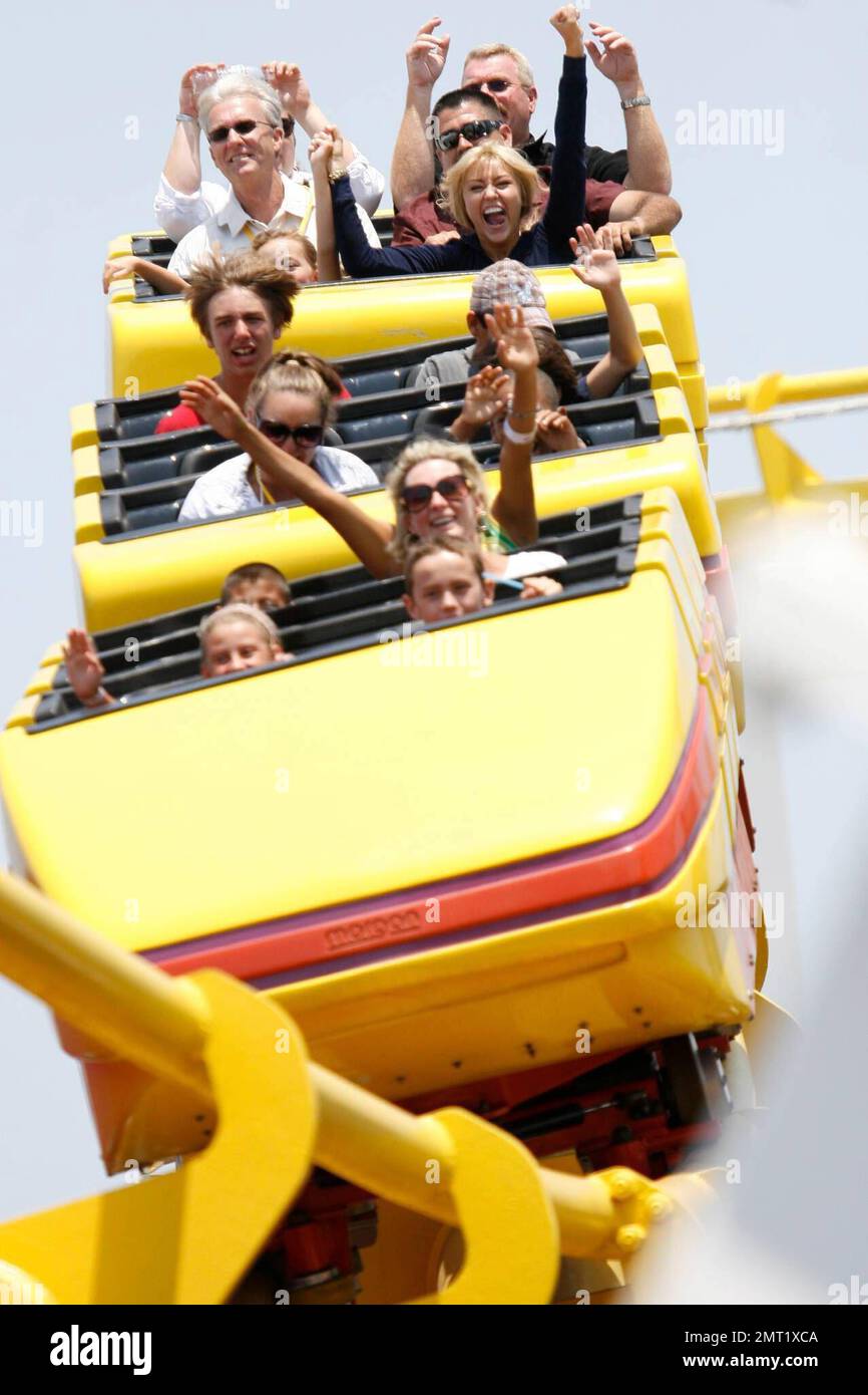Miley Cyrus has fun on the rides with her sister (check) at the Santa ...