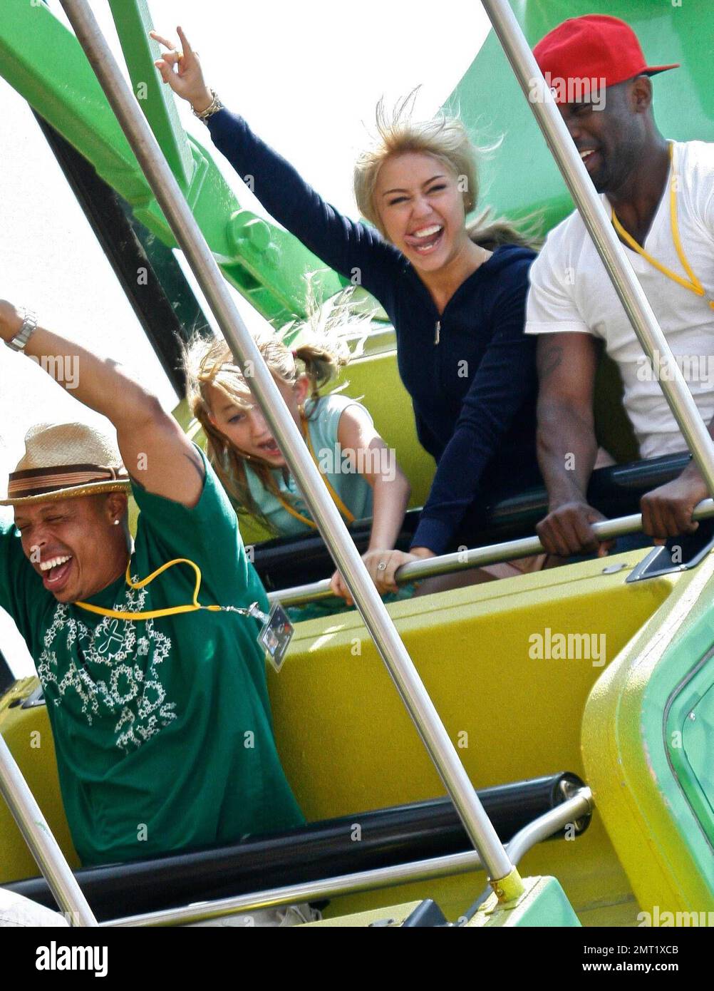 Miley Cyrus has fun on the rides with her sister (check) at the Santa ...