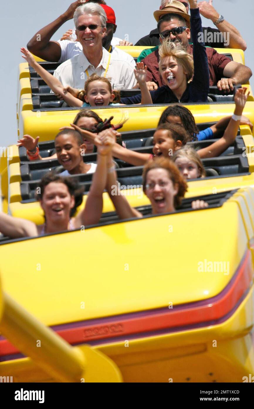 Miley Cyrus has fun on the rides with her sister (check) at the Santa ...