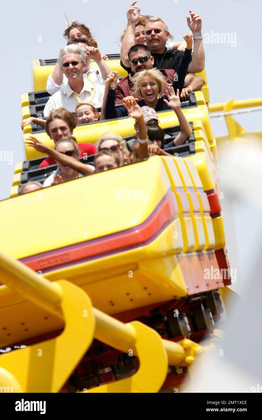 Miley Cyrus has fun on the rides with her sister (check) at the Santa ...