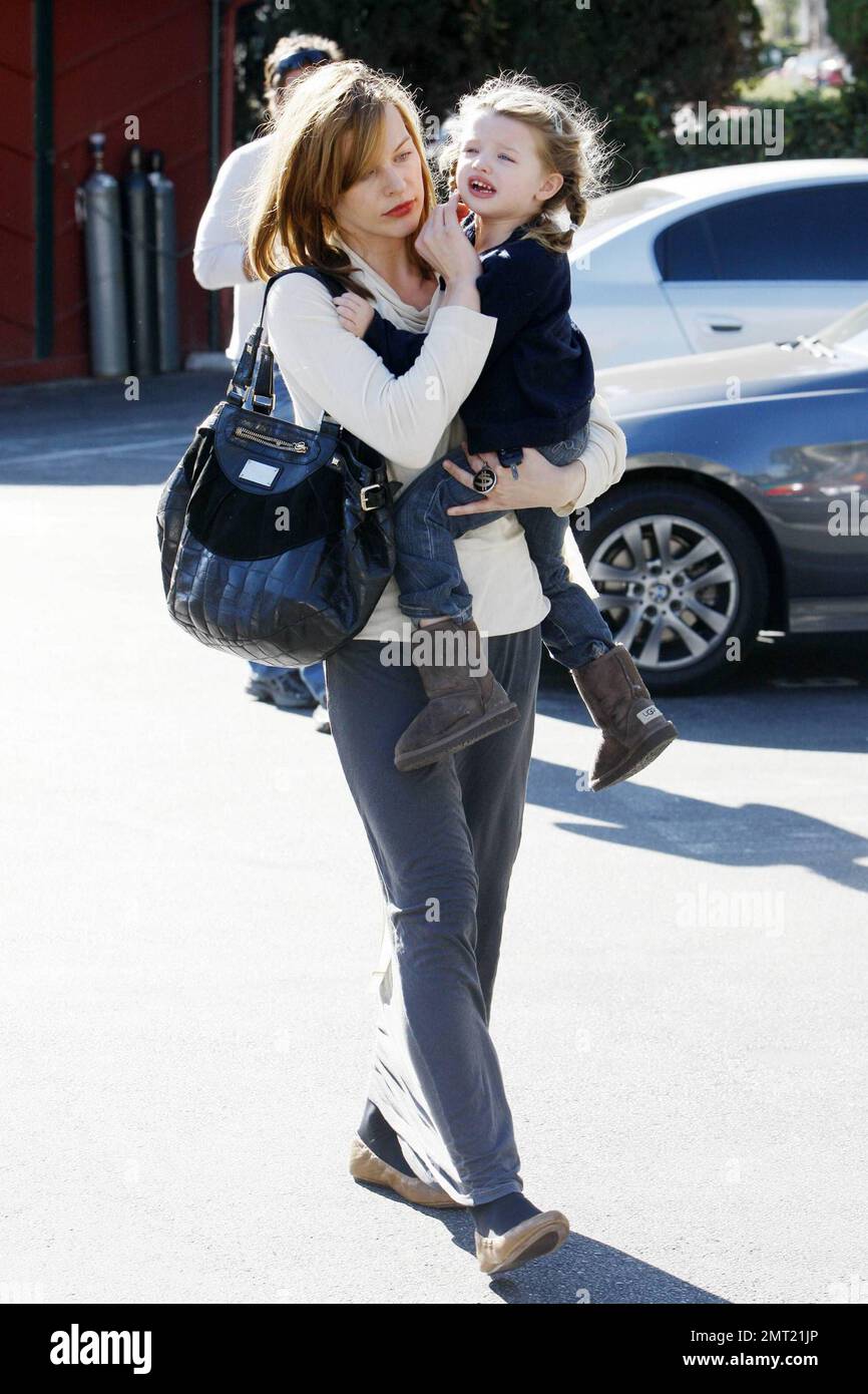 Model and actress Milla Jovovich comforts three-year-old daughter Ever ...
