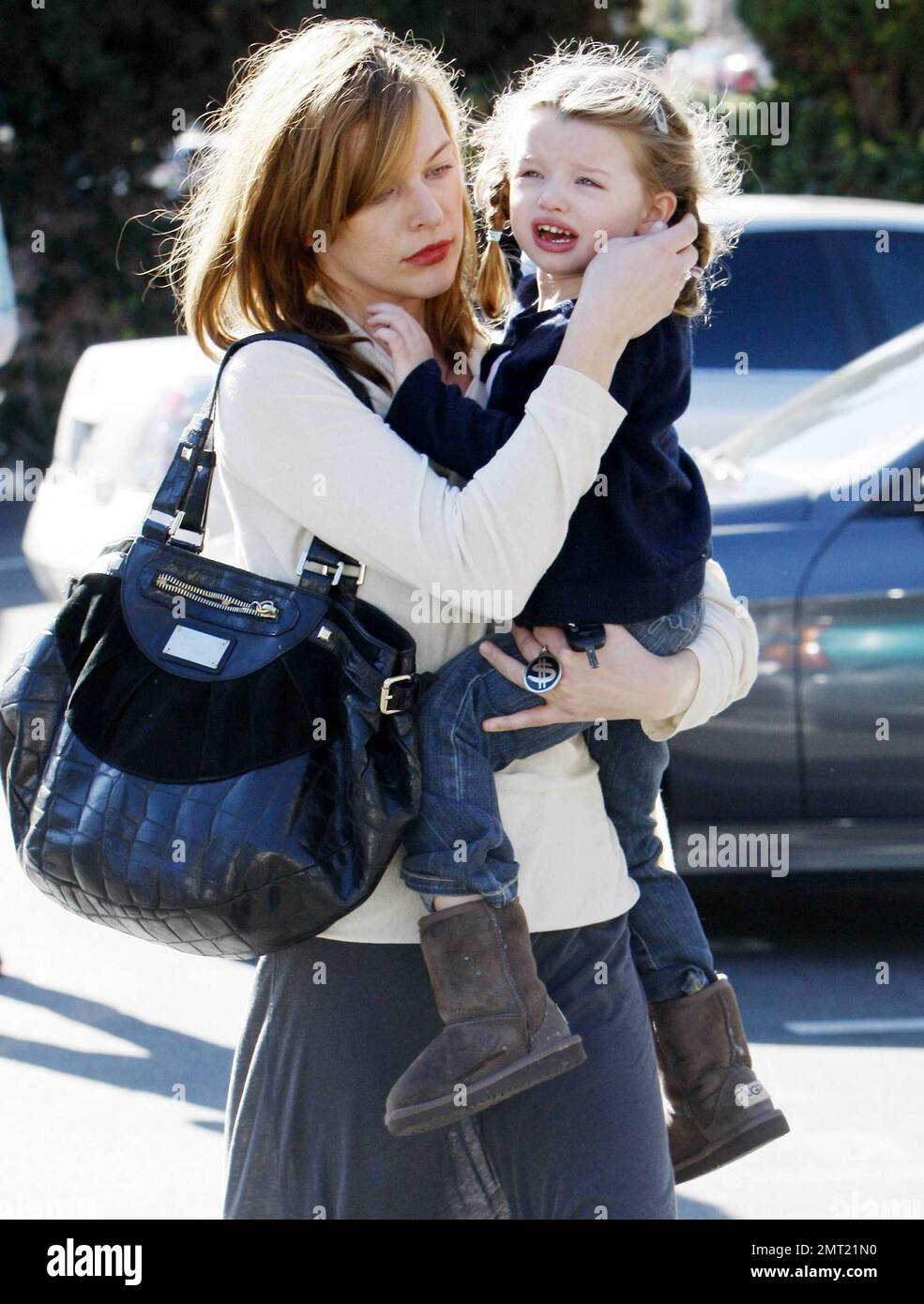 Model and actress Milla Jovovich comforts three-year-old daughter Ever ...