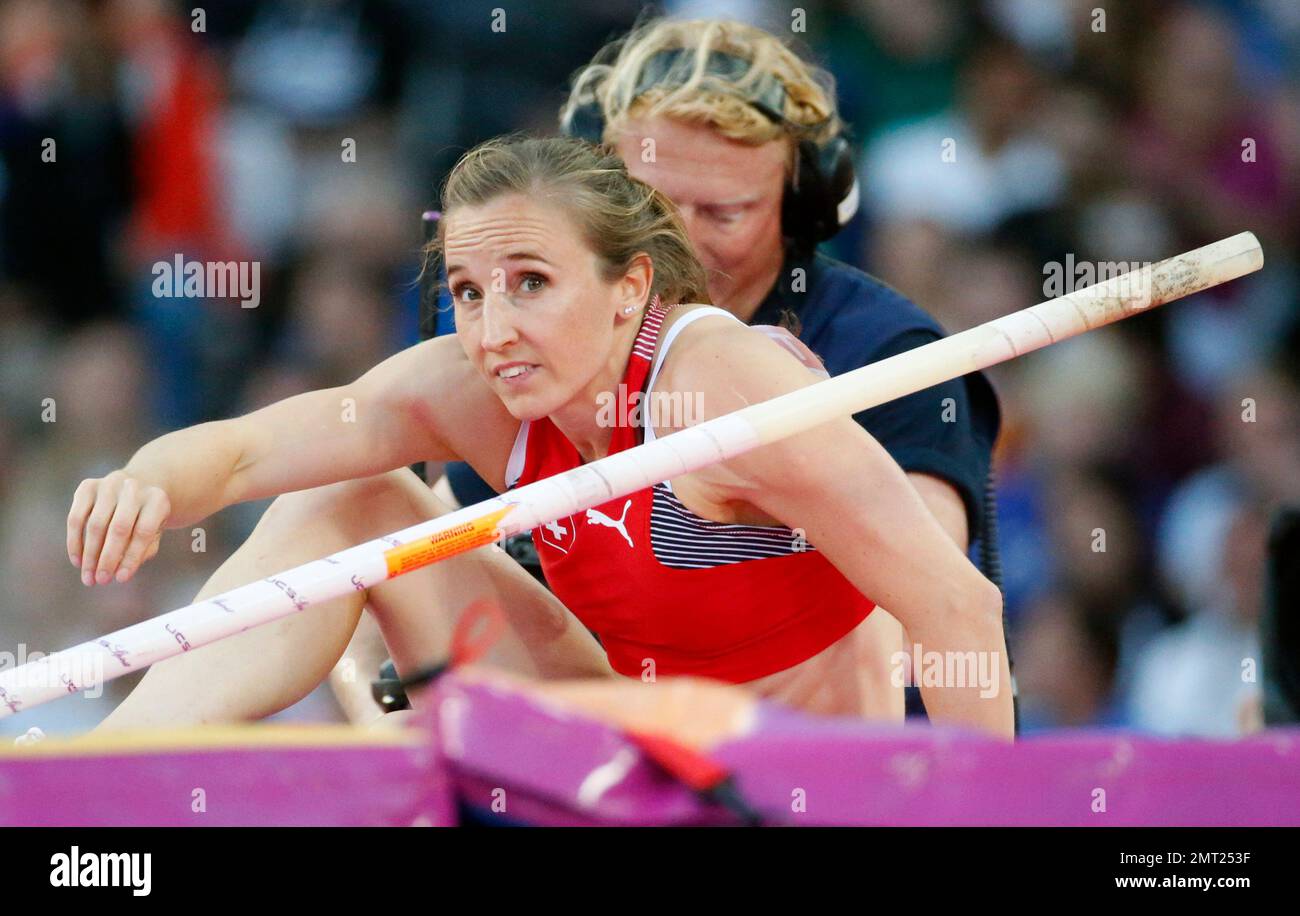 Switzerland's Nicole Buechler sits on the mat after an attempt in the ...