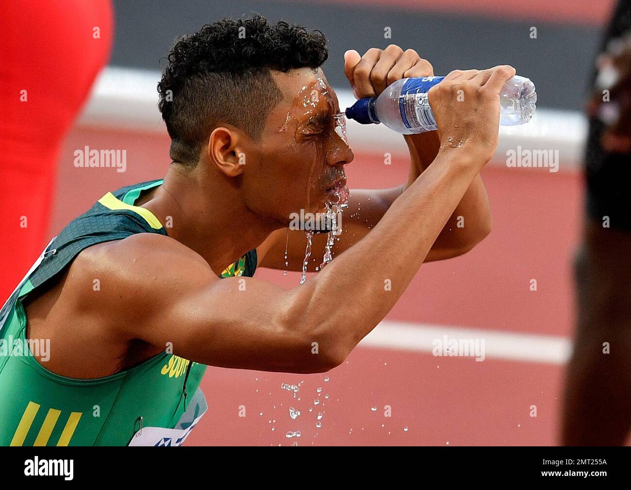 South Africa's Wayde Van Niekerk sprays water over his face following ...