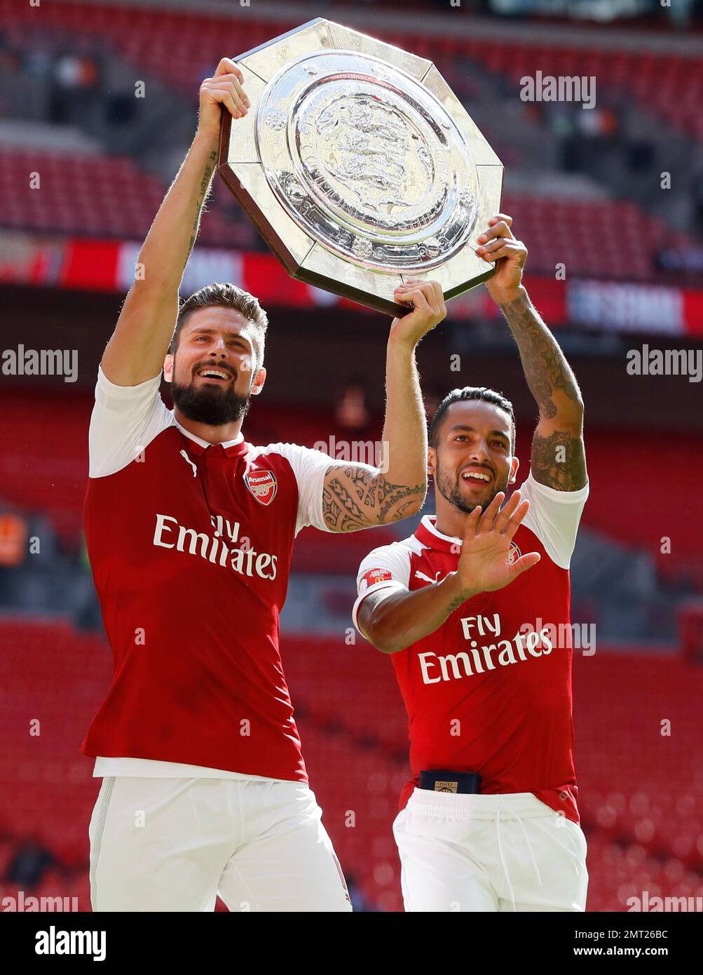 Arsenal's Olivier Giroud, left, and Arsenal's Theo Walcott hold up the ...