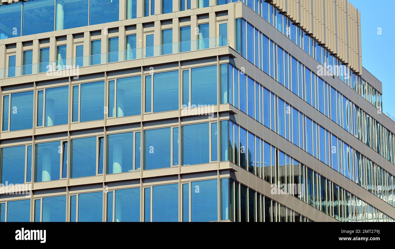 Abstract closeup of the glass-clad facade of a modern building covered ...