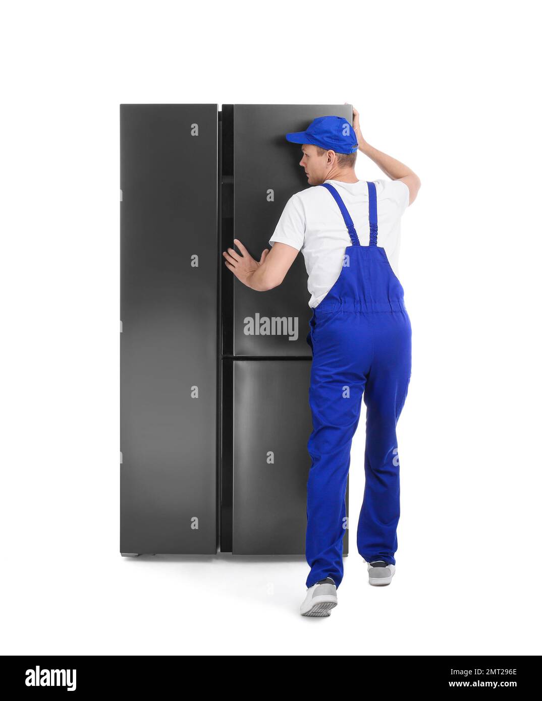 Professional worker carrying refrigerator on white background Stock ...