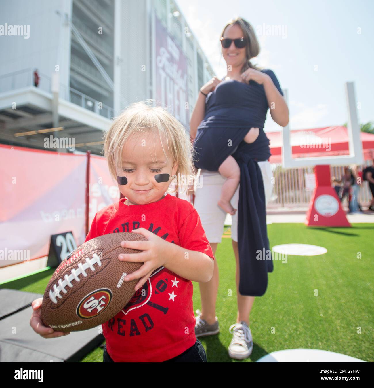 IMAGES DISTRIBUTED FOR HUGGIES - Tai Tesimale, 2, holds a football near ...
