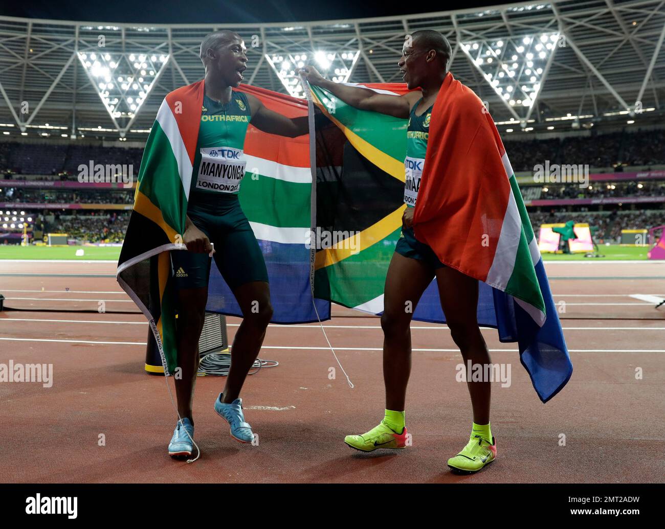 South Africa's gold medal winner Luvo Manyonga, left, celebrates with ...