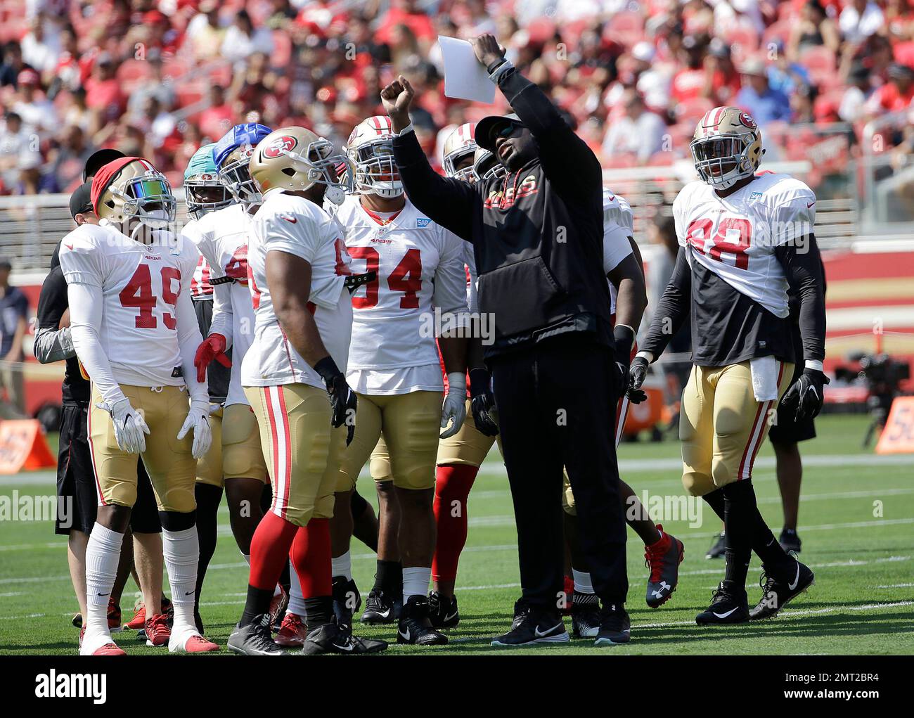 San Francisco 49ers assistant coach Vince Oghobaase gives instructions ...