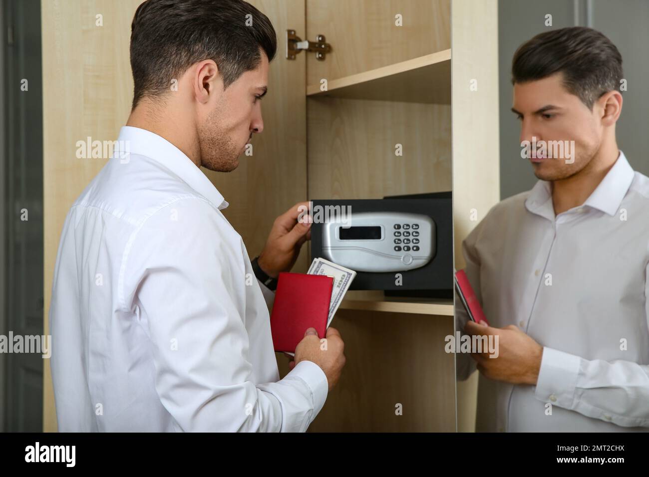 Man opening black steel safe with electronic lock at hotel Stock Photo ...