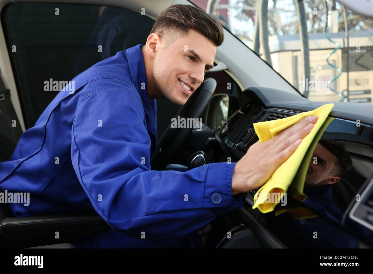 Car wash worker cleaning modern automobile interior Stock Photo - Alamy