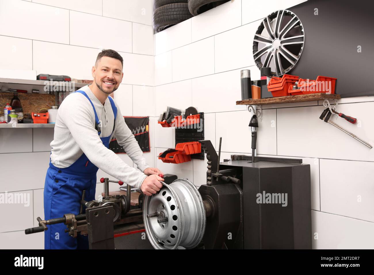 Mechanic working with car disk lathe machine at tire service Stock ...