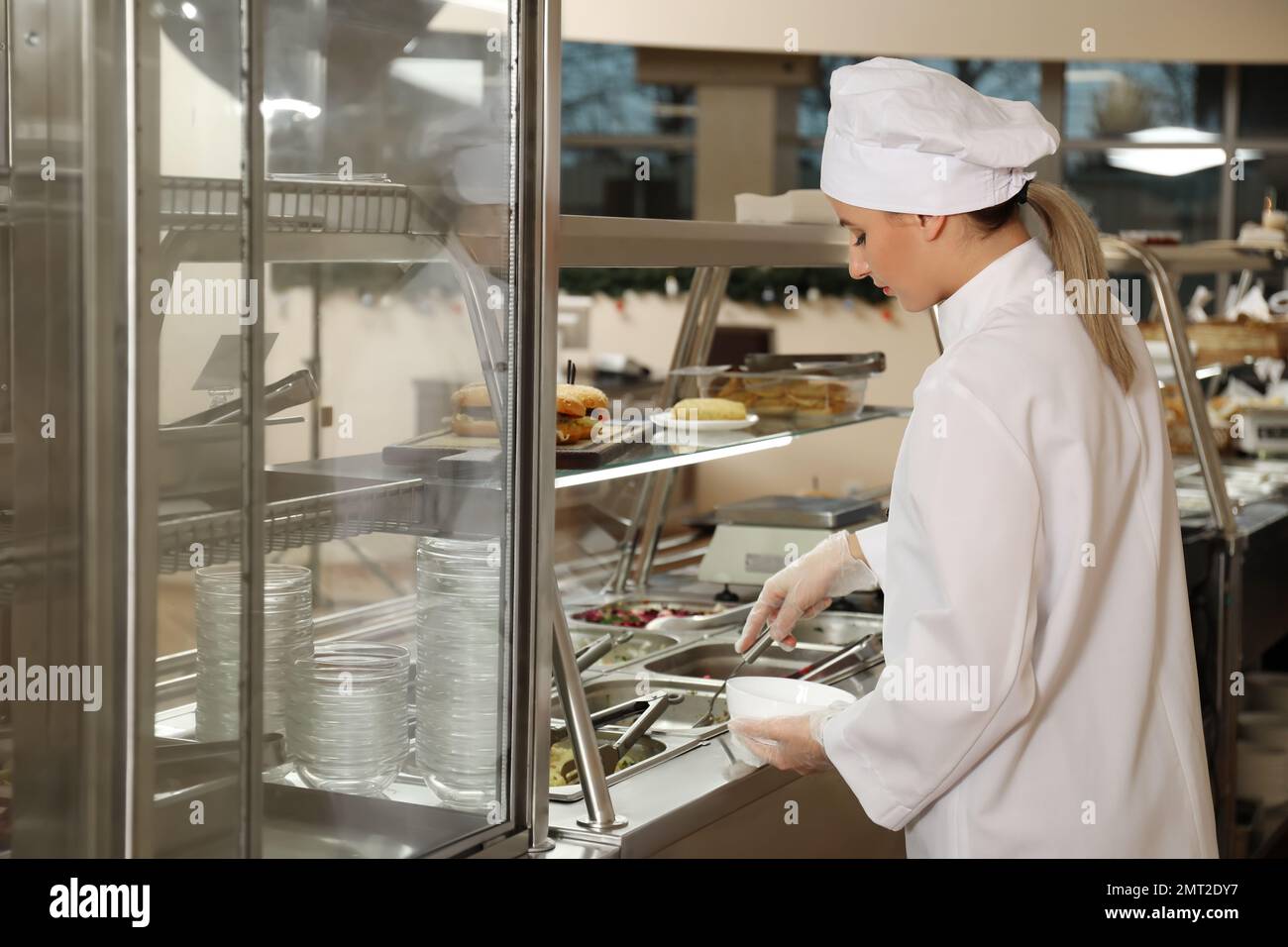 School canteen worker at serving line. Tasty food Stock Photo - Alamy