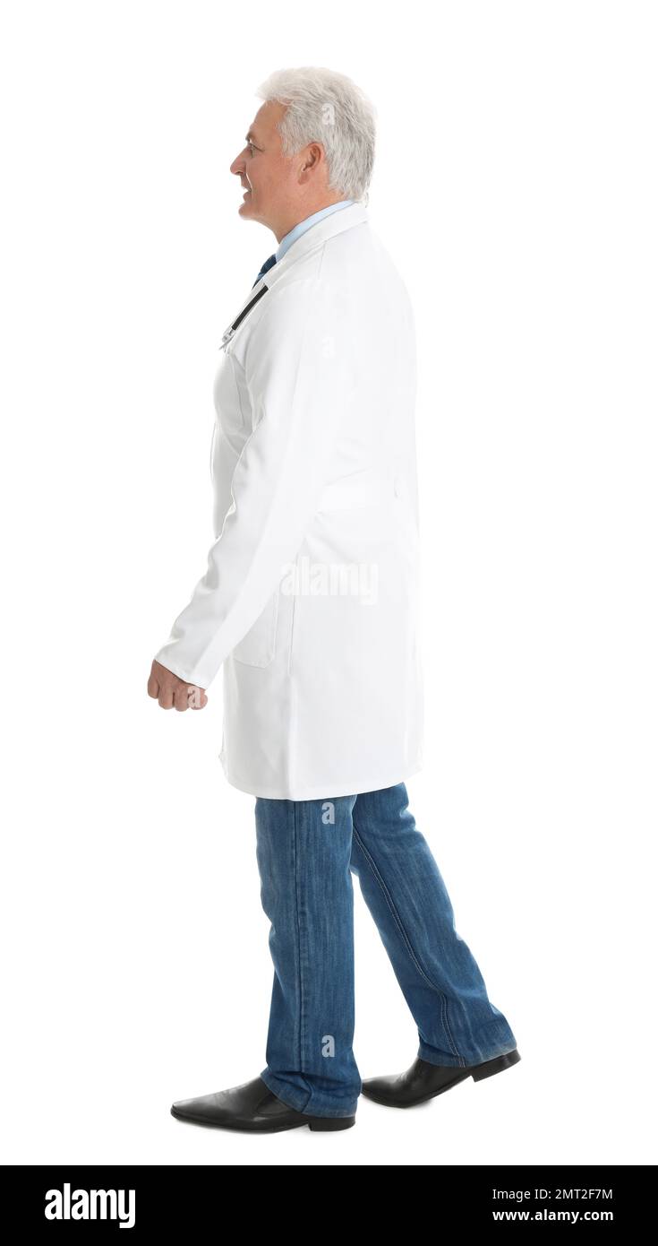 Full length portrait of senior doctor walking on white background Stock ...