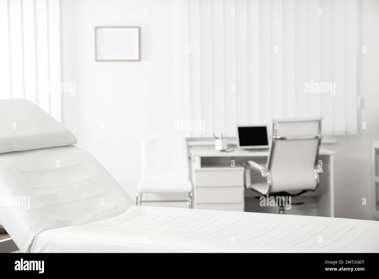 Modern medical examination couch in doctor's office Stock Photo - Alamy