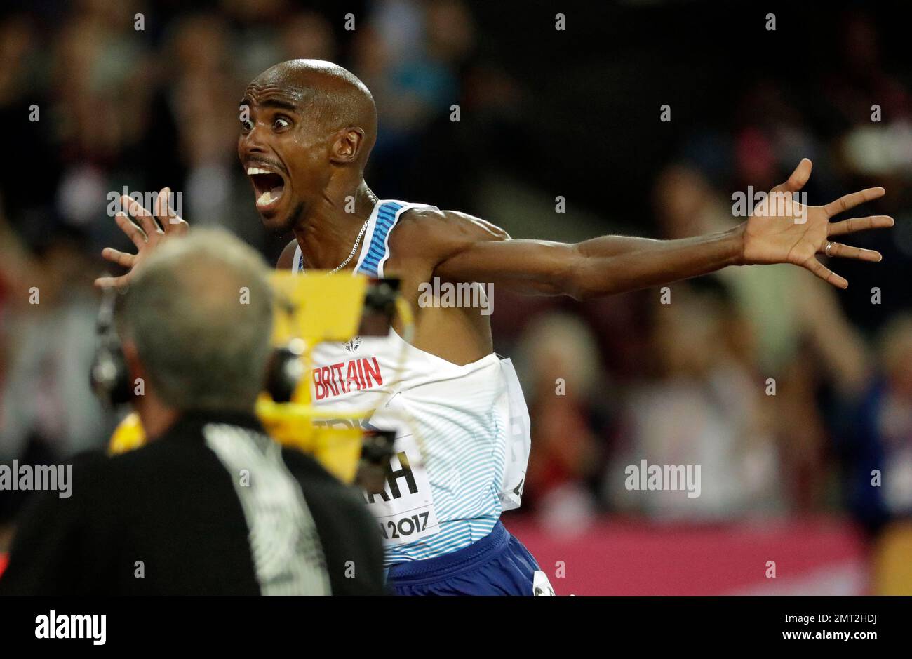Britain's Mo Farah crosses the line to take the gold in the men's ...