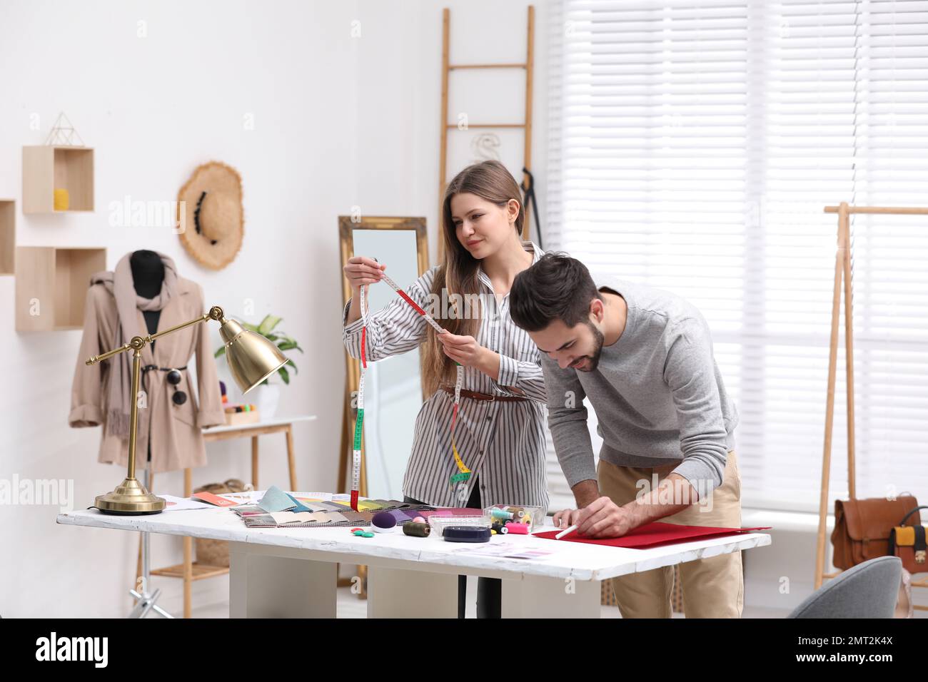 Fashion designers creating new clothes in studio Stock Photo - Alamy