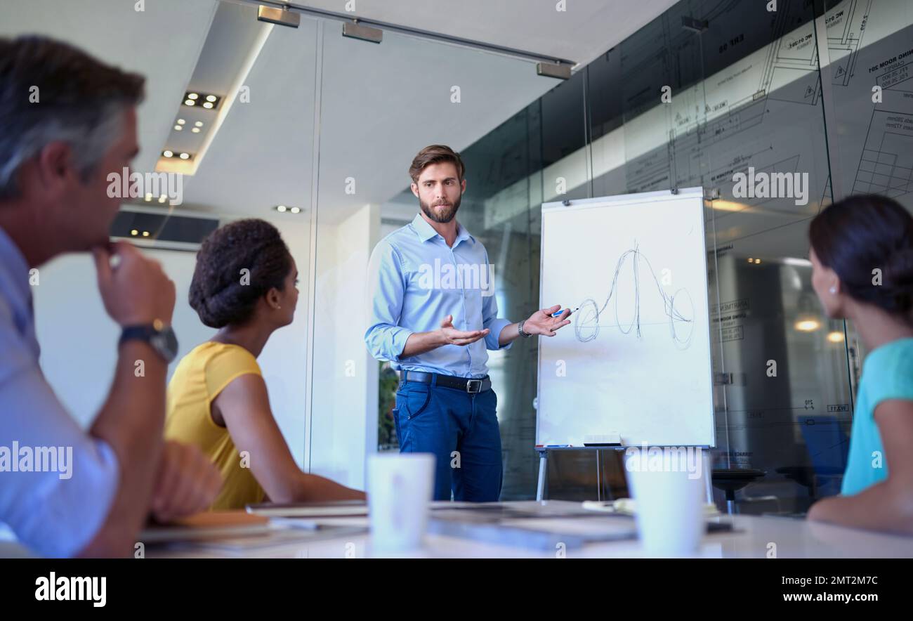 Explaining it as best he can. a handsome young man giving a business ...