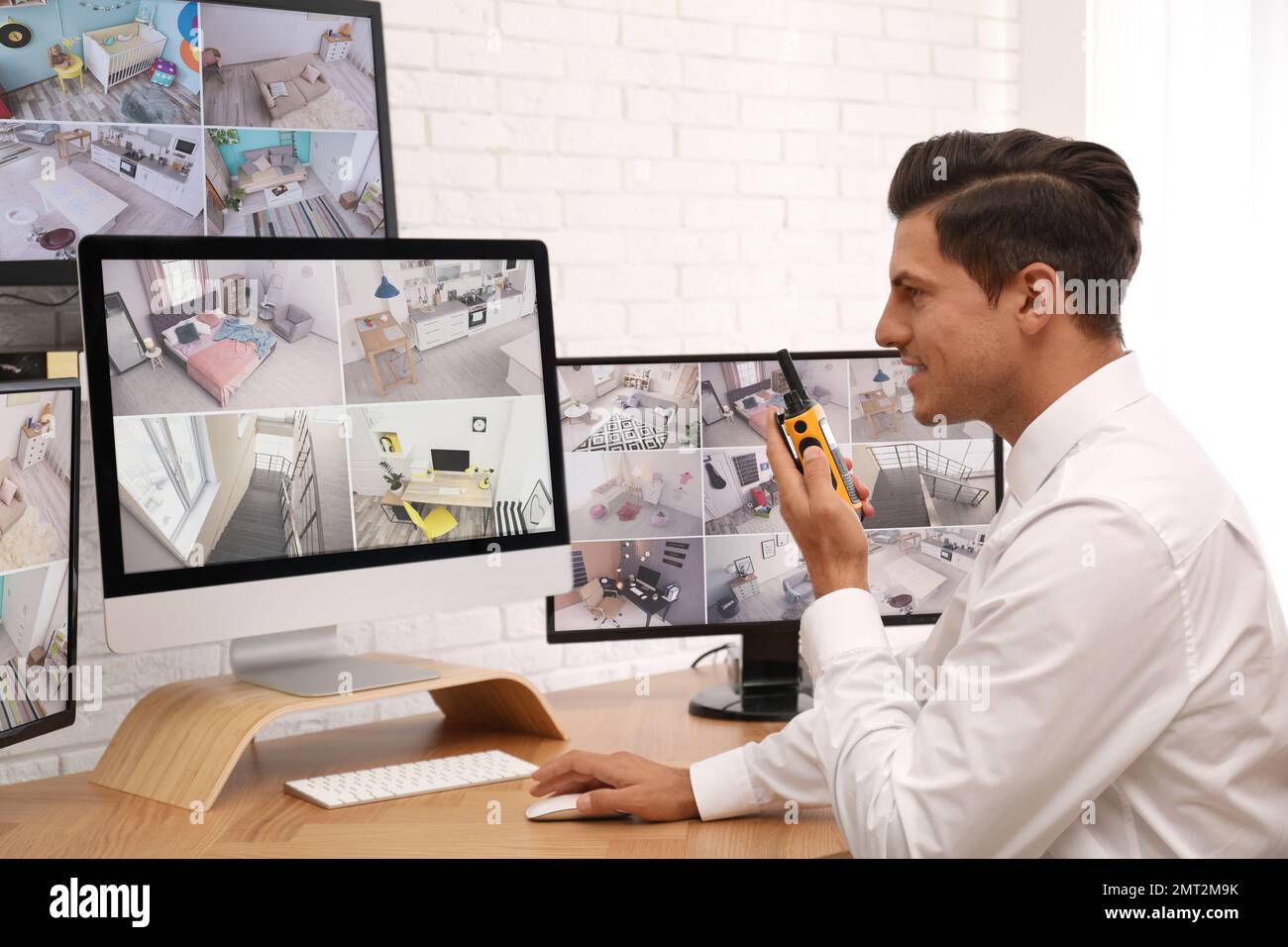 Male security guard with portable transmitter at workplace Stock Photo ...