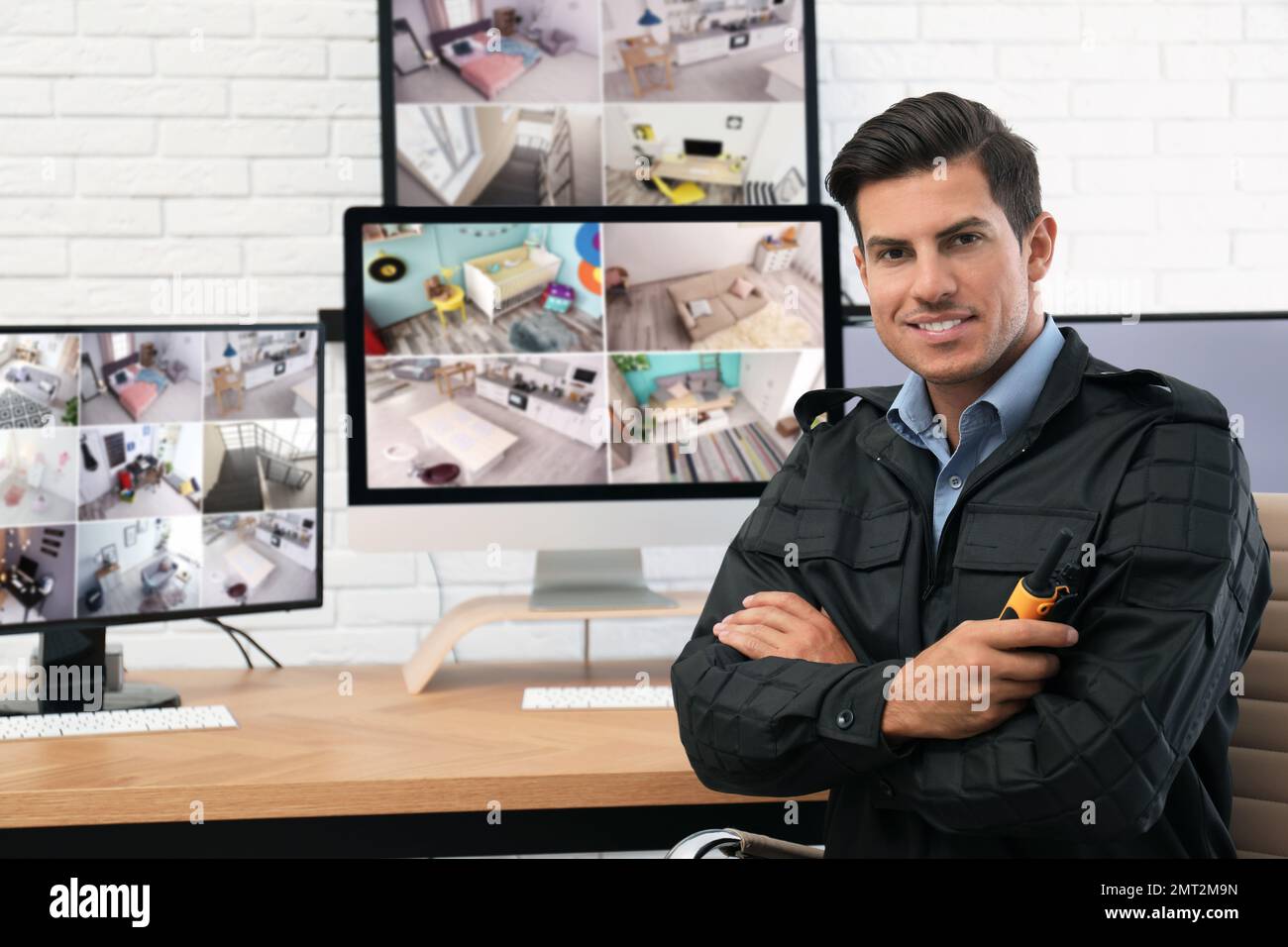 Male security guard with portable transmitter at workplace Stock Photo ...