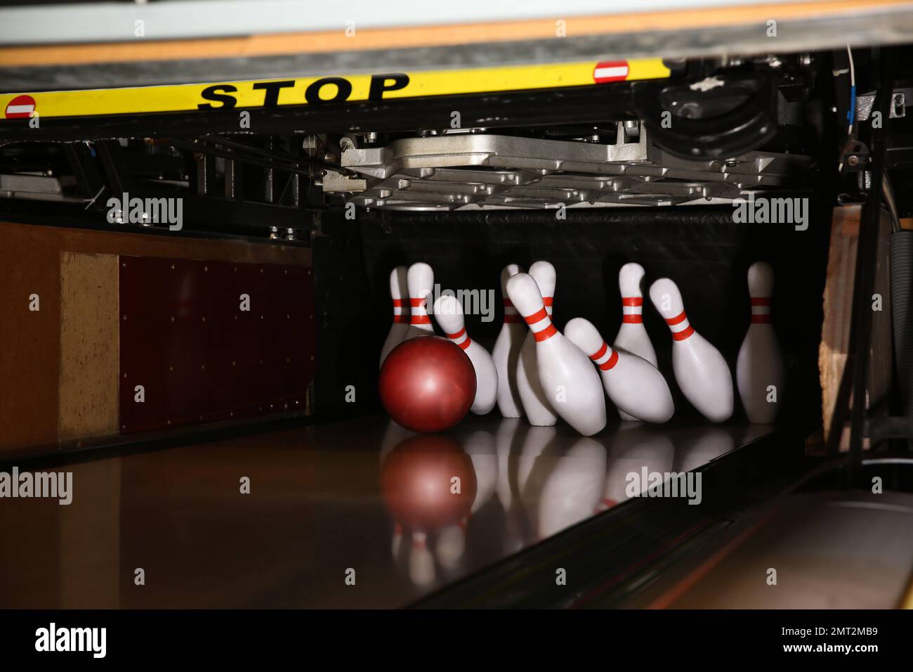 Ball hitting pins on alley in bowling club Stock Photo - Alamy