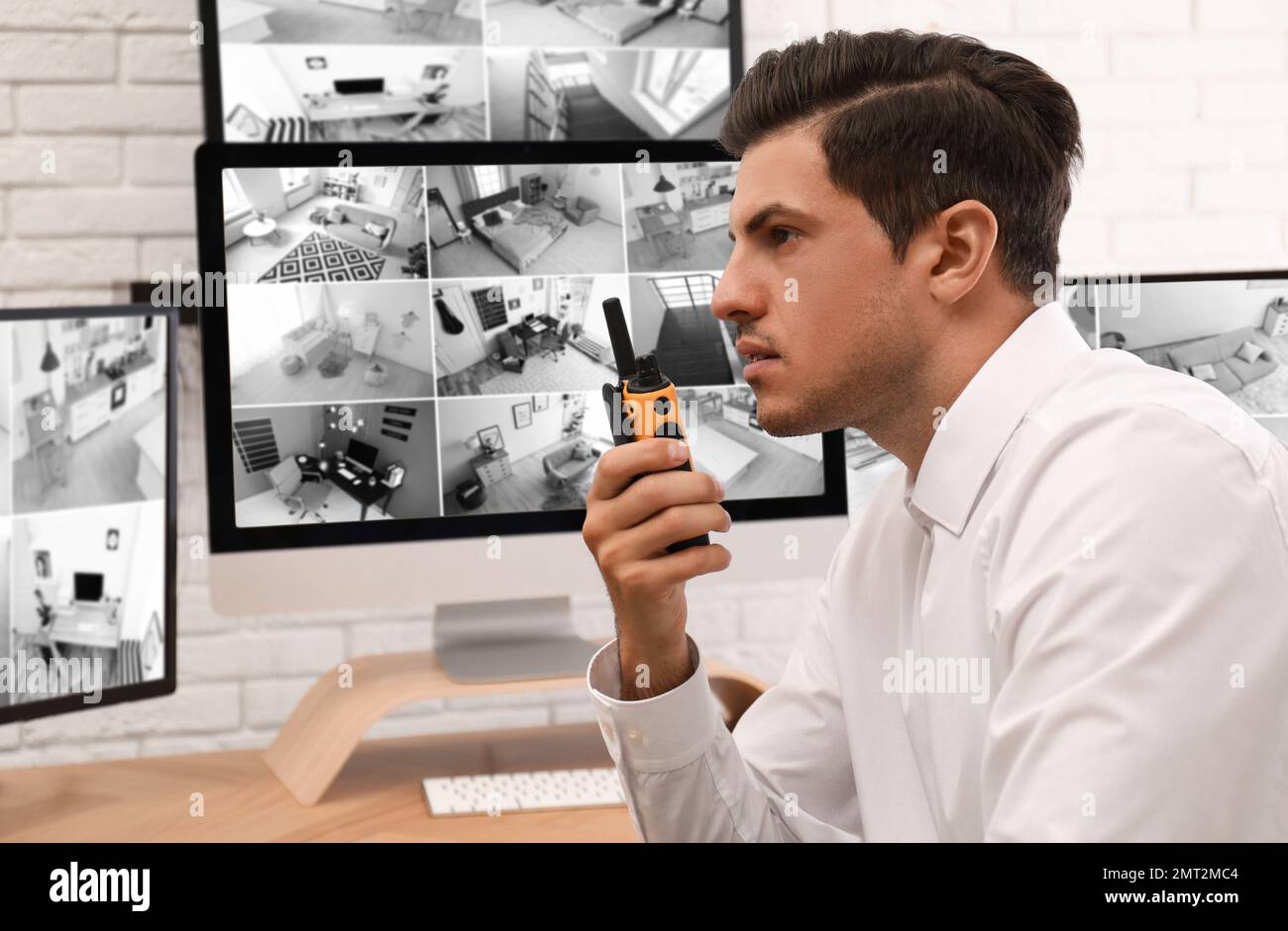 Male security guard with portable transmitter at workplace Stock Photo ...