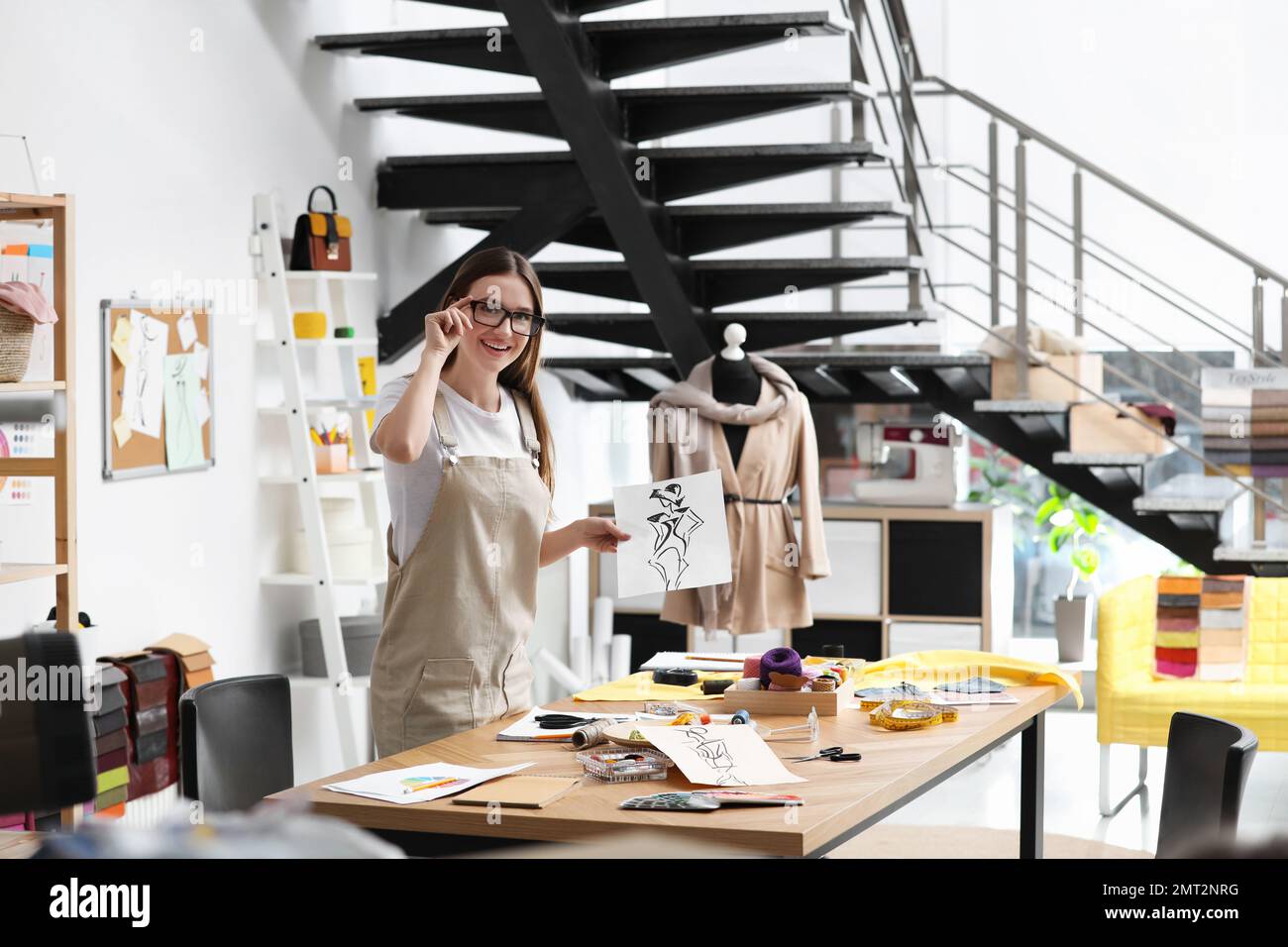 Fashion designer creating new clothes in studio Stock Photo - Alamy