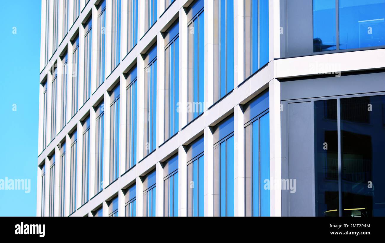 Abstract closeup of the glass-clad facade of a modern building covered ...