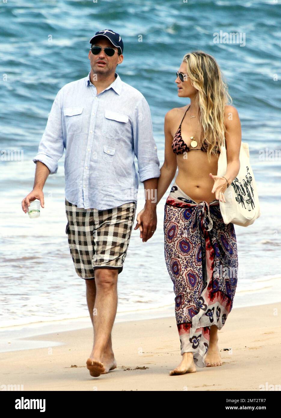 Newlyweds Molly Sims, 38, and Scott Stuber, 42, stroll hand-in-hand on the beach while enjoying ...