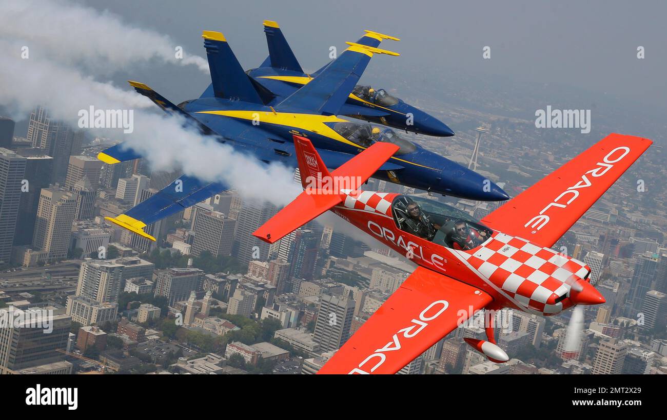 Stunt pilot Sean D. Tucker, right, flies his Team Oracle Extra 300L in ...