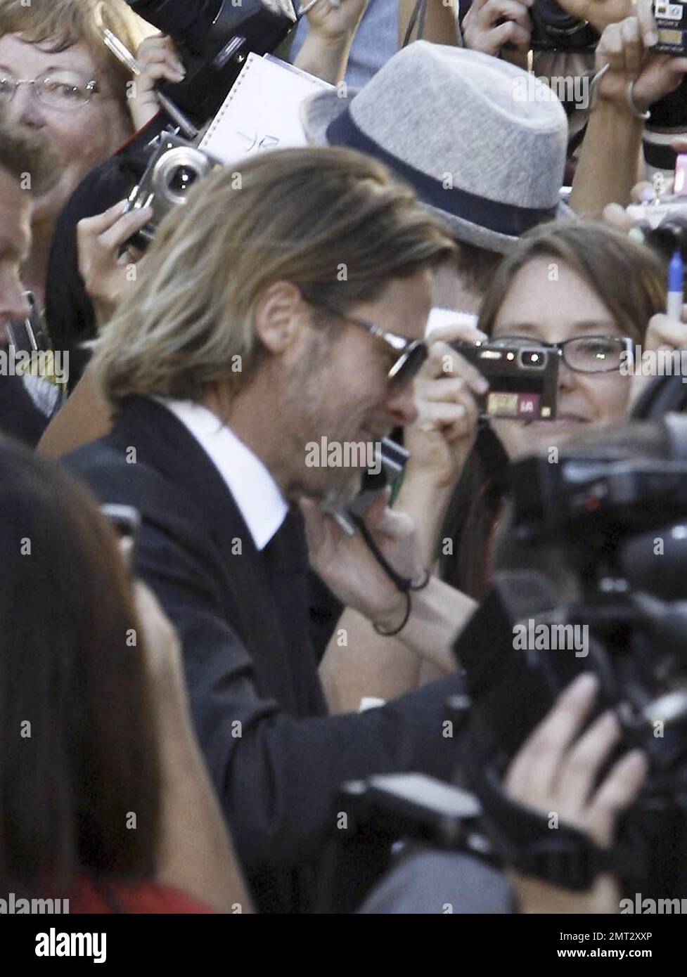 Brad Pitt signs autographs for fans at the "Moneyball" Premiere at the ...