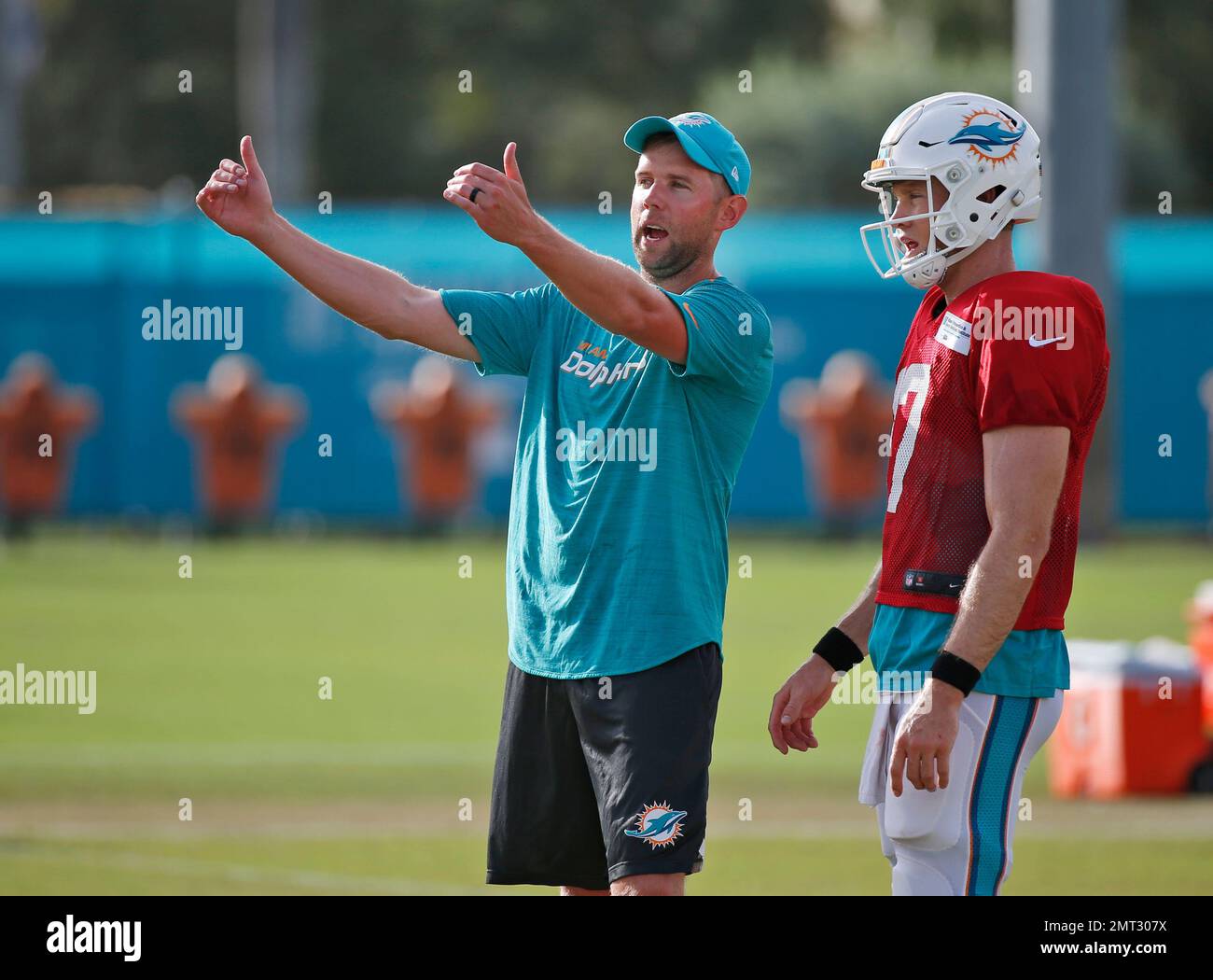 Miami Dolphins quarterbacks coach Bo Hardegree, left, talks with ...