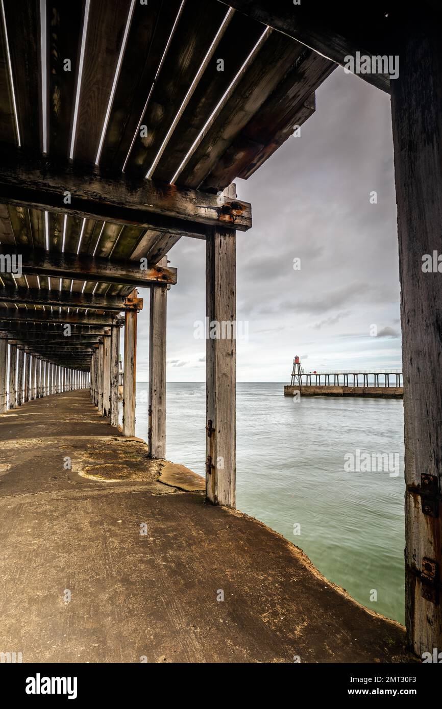 The under interior of a wooden boardwalk bridge Stock Photo - Alamy