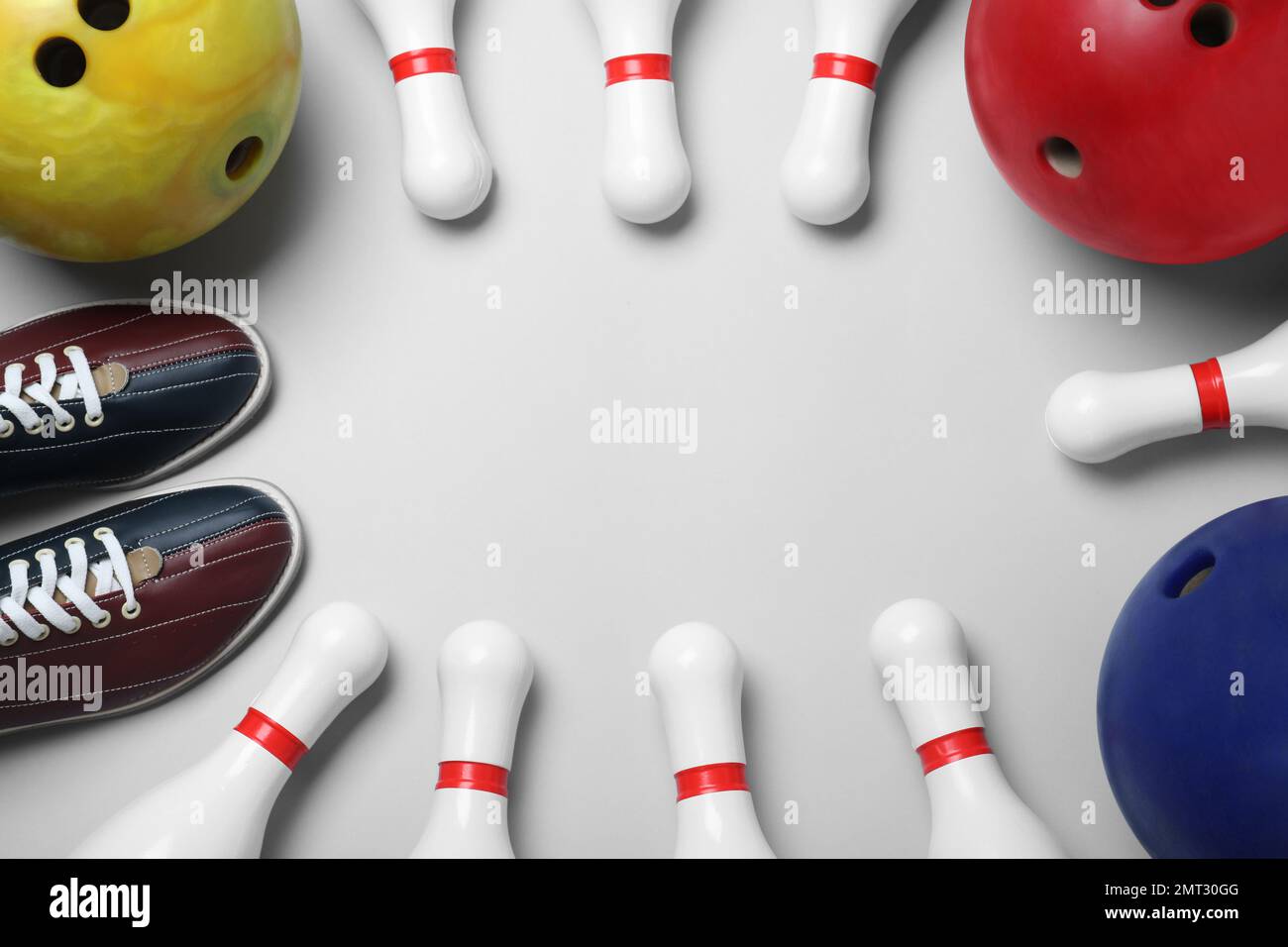 Composition with bowling balls, shoes and pins on white background ...