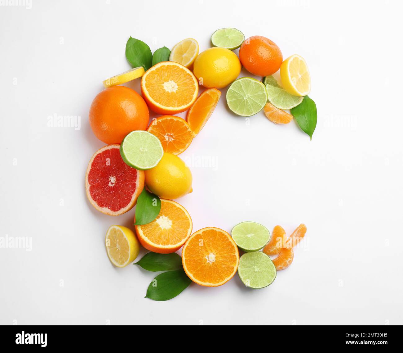 Letter C made with citrus fruits on white background as vitamin ...